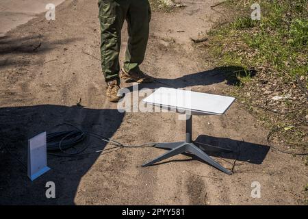 Ukrainian soldier using Starlink, a satellite internet constellation ...