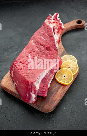 front view fresh meat slices raw meat with seasonings on a dark ...