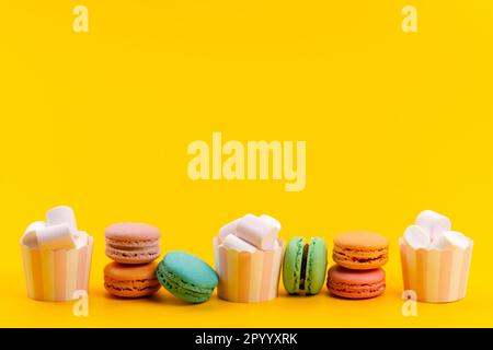 a front view french macarons along with candies and lollipops inside ...