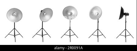 Set with studio flash lights with reflectors on tripods against white ...