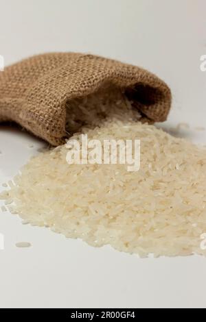 spilled rice grains - white background Stock Photo - Alamy