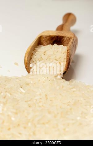 spilled rice grains - white background Stock Photo - Alamy