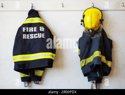 Firefighter coat hanging on fire truck Stock Photo - Alamy