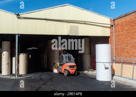 Forklift with clamps to move reels of paper in a warehouse Stock Photo ...
