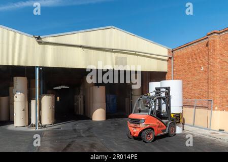 Forklift with clamps to move reels of paper in a warehouse Stock Photo ...