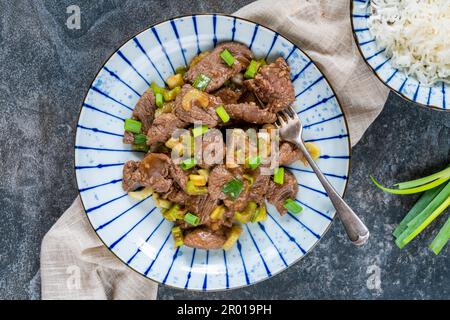 Steak and celery stir fry with rice Stock Photo - Alamy