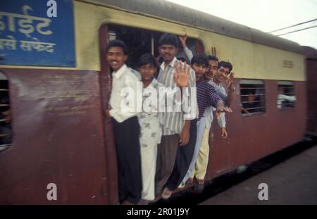 a overloaded Train on the way to the Mumbai Railway Station or ...