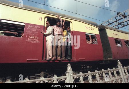 a overloaded Train on the way to the Mumbai Railway Station or ...