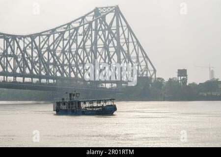 A motorized ferry is sailing at the holy river Ganga with the ...