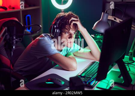 Young blond man streamer stressed using computer at gaming room Stock ...