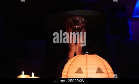 Young bald man wearing wizard costume doing magic gesture at home Stock ...