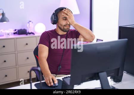 Young latin man streamer stressed using computer at gaming room Stock ...