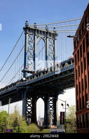 Iconic view of Manhattan Bridge from Washington Street. Red brick ...
