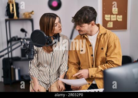 Mand and woman musicians singing song playing piano keyboard at music ...