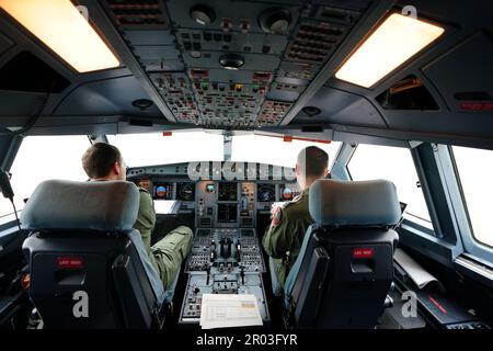 Crew members in the cockpit of a Royal Air Force (RAF) Voyager, flying ...