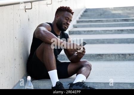 young black man outdoor using smart phone - business, remote working ...