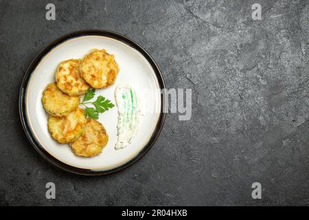top view cooked squashes slices inside plate on the grey background ...