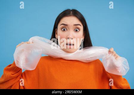 Woman suffocating, being choked by plastic bag, concept of ecology ...