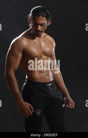Portrait of muscular mid adult man in gym Stock Photo - Alamy