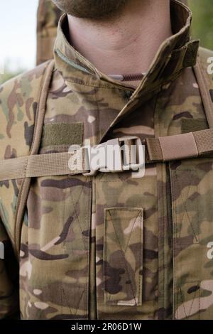 Preparing for Combat: Close-up of Soldier Putting on Gear in the Field ...