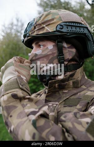 Calm Soldier in Tactical Helmet and Camo Balaclava Ready for Action and ...