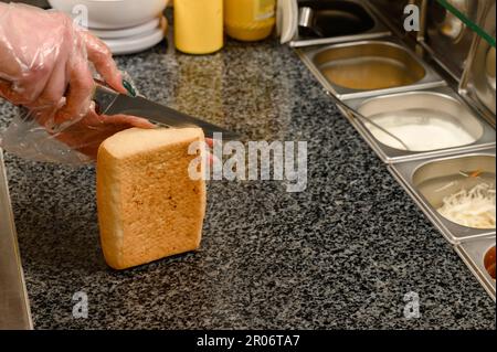 The process of making a panini in a fast food restaurant, a panini bun ...