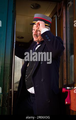 Reenactment scene with authentic 1927 1st class train carriage and a ...