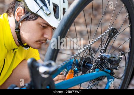 Male racer checking gear condition during a short break. Timely ...