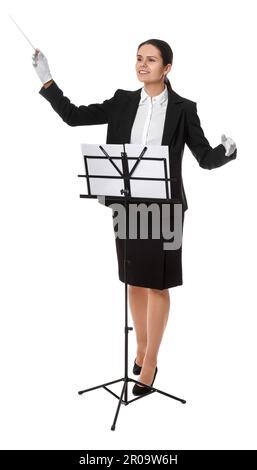 Happy young conductor with baton and note stand on white background ...