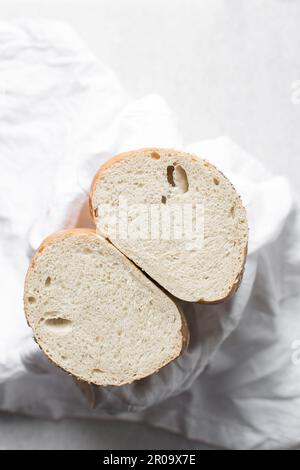 Cross-section of artisan bread cut into half, top view of sesame coated ...