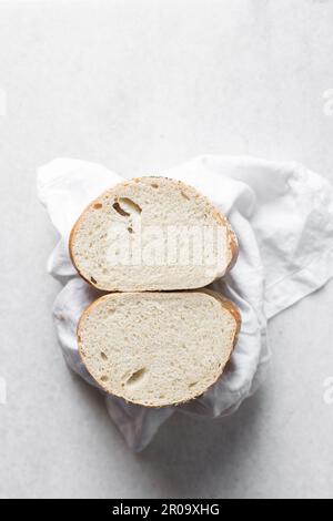 Cross-section of artisan bread cut into half, top view of sesame coated ...
