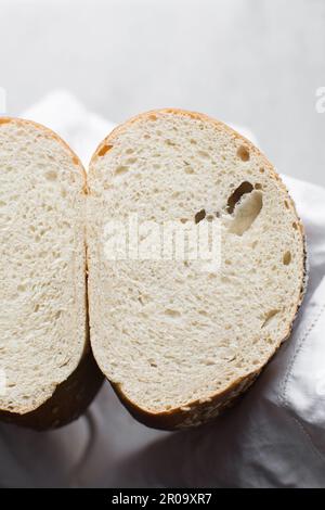 Cross-section of artisan bread cut into half, top view of sesame coated ...
