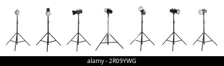 Set with studio flash lights with reflectors on tripods against white ...
