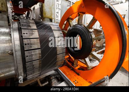 Rolling drum with rubber layers to form car tire at plant Stock Photo ...