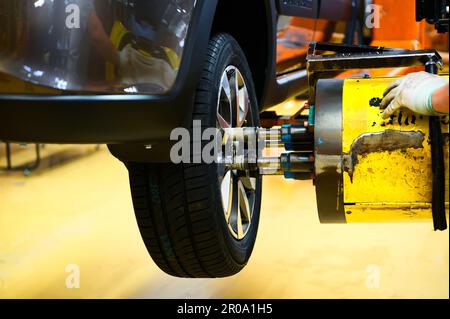 Employee fastens car wheel with automatic spanner in shop Stock Photo ...