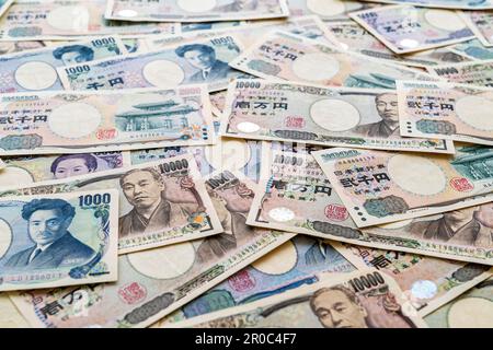 Japanese currency. View looking down at a pile of Japanese banknotes in ...