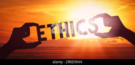 Integrity - human hands holding black silhouette word Stock Photo - Alamy