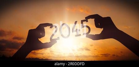 2045 - human hands holding black silhouette year number, gradient ...