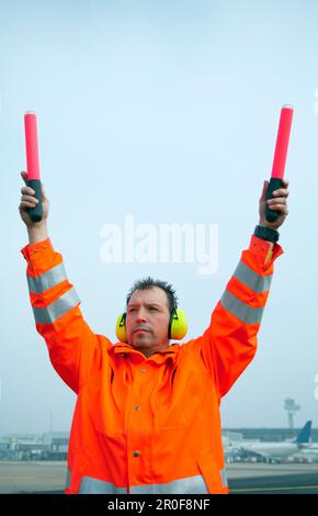 Airport ground crew signaling to aircraft, Airport Düsseldorf, North ...