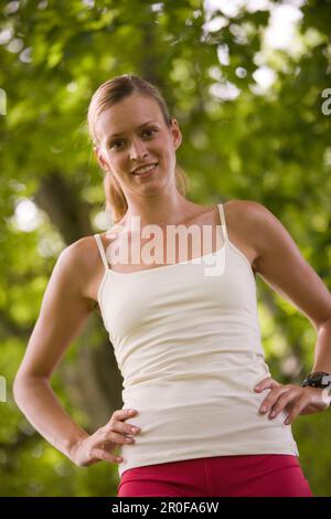 Woman with hands on hips, outdoors Stock Photo - Alamy