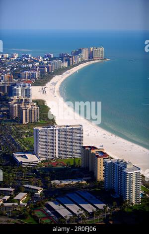 An aerial view of Marco Island, Florida with lush green vegetation and ...