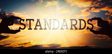 Standards - human hands holding black silhouette word, gradient ...
