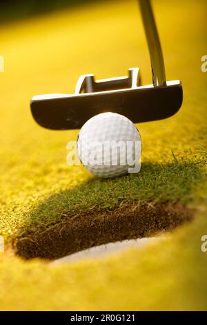 Golf ball near hole, Strasslach-Dingharting, Bavaria, Germany Stock ...