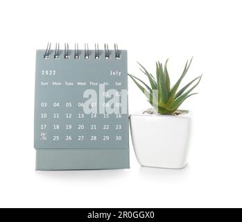 The July 2022 desk calendar with plant pot on wooden table Stock Photo ...