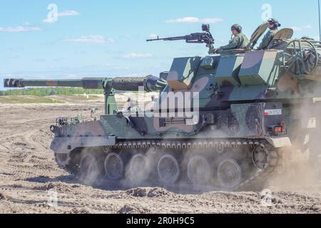 Polish soldiers maneuver an AHS Krab, a self-propelled tracked gun ...