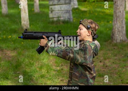 Boy playing laser tag Stock Photo - Alamy