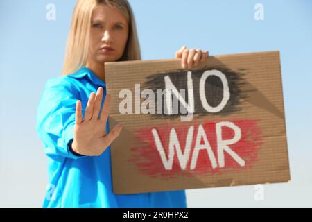 woman with poster showing stop gesture Stock Photo - Alamy