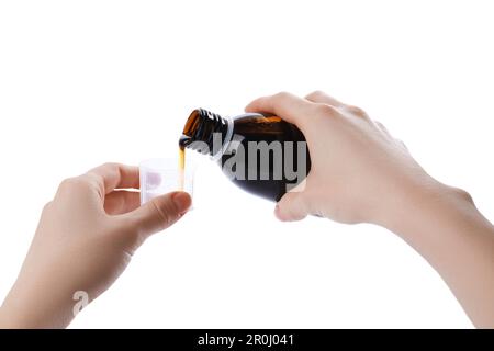 Woman pouring syrup into measuring cup from bottle isolated on white ...