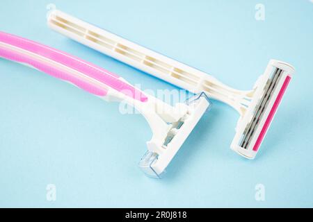 Pink and blue razors on white background Stock Photo - Alamy