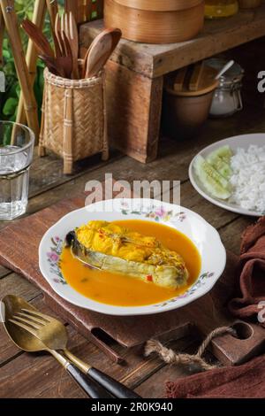 Silver catfish cooked with spicy coconut milk and fermented durian. A ...